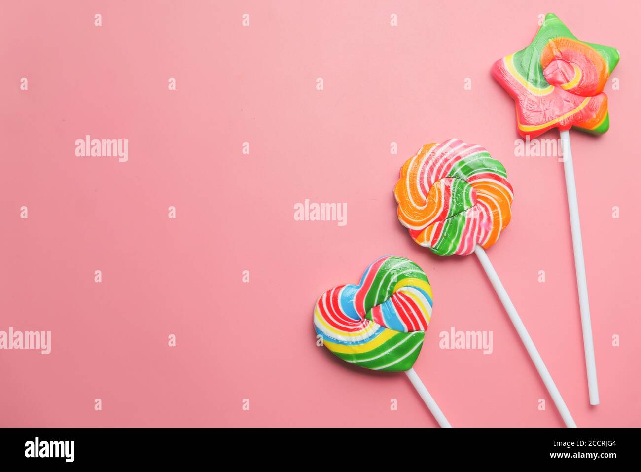 Top view of colorful lollipop on pink background Stock Photo - Alamy