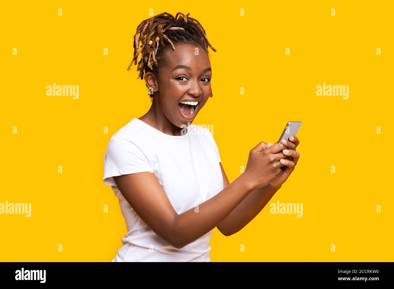 Excited black woman using mobile phone, got new nice app Stock Photo ...