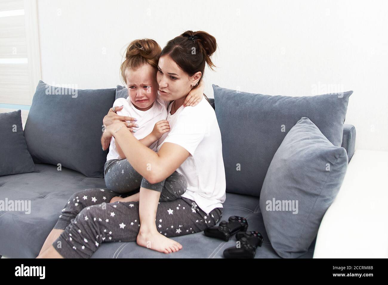 Mother hugging daughter sad hi-res stock photography and images - Alamy