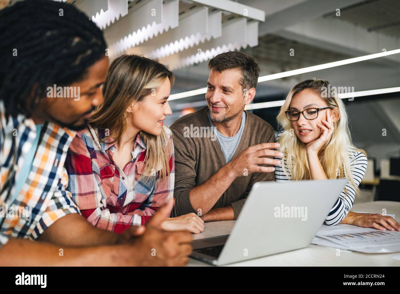 Group of business people and software developers working as a team in ...