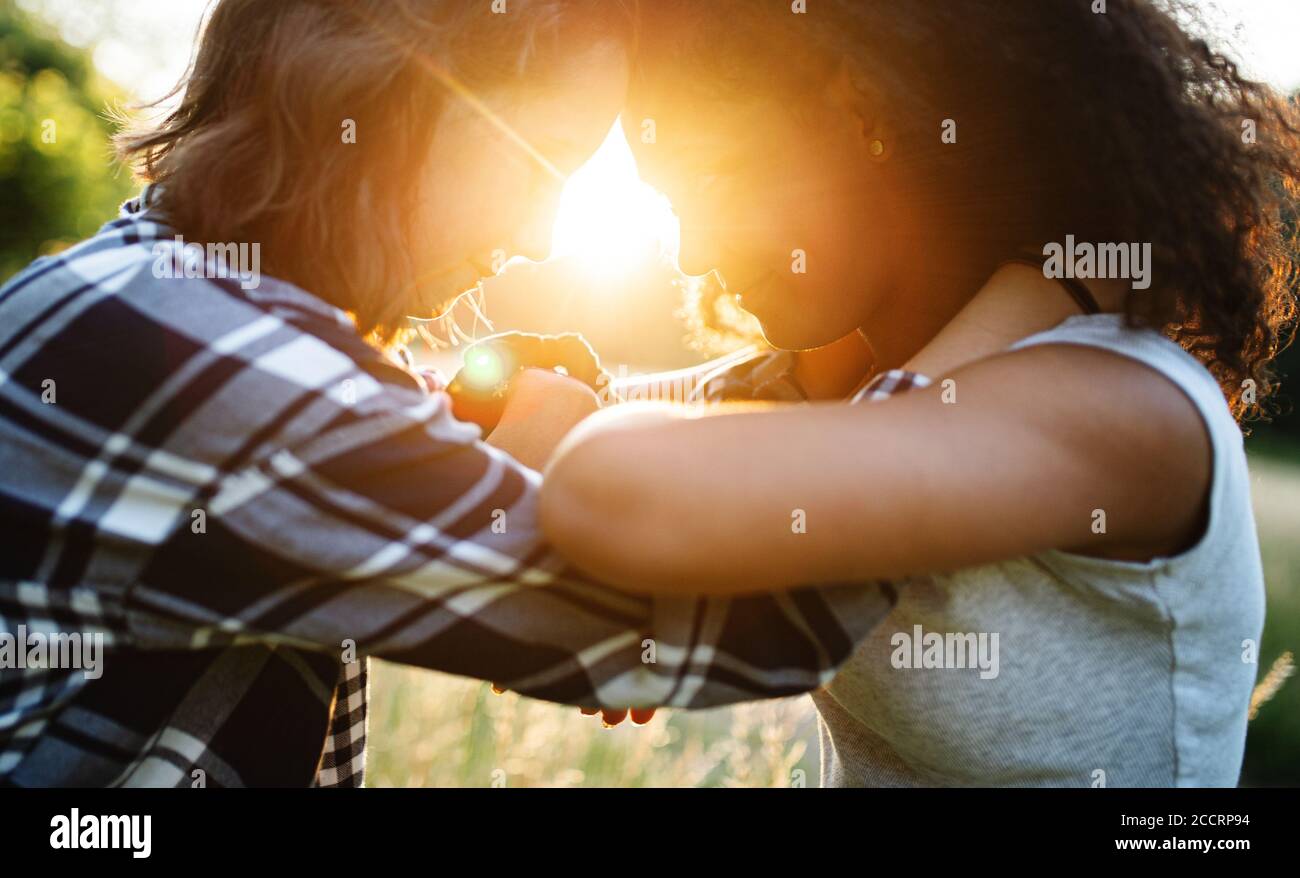 Side view of young teenager girls friends outdoors in nature at sunset ...