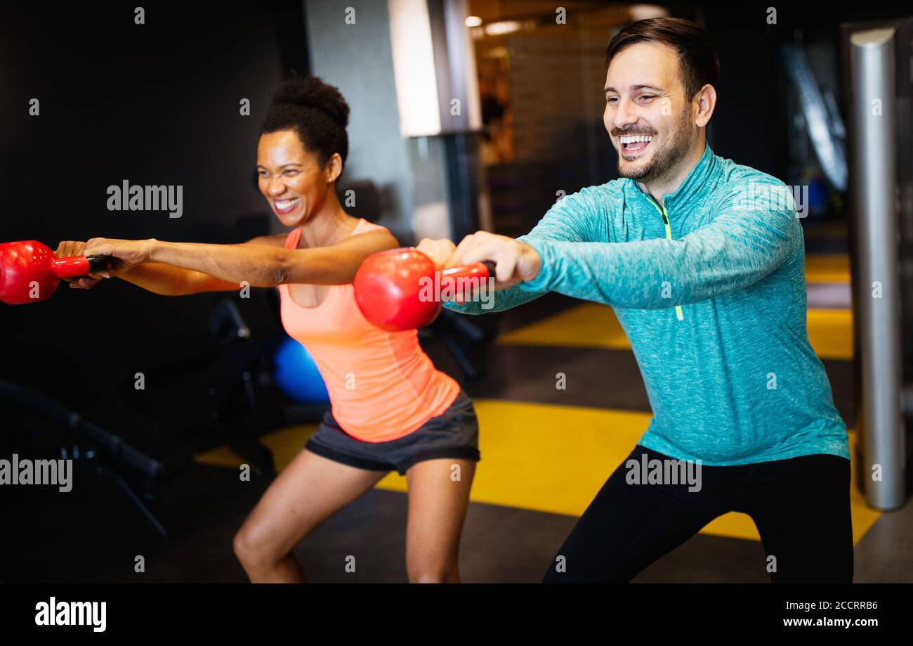 Group of fit people in gym training. Multiracial group of friends ...