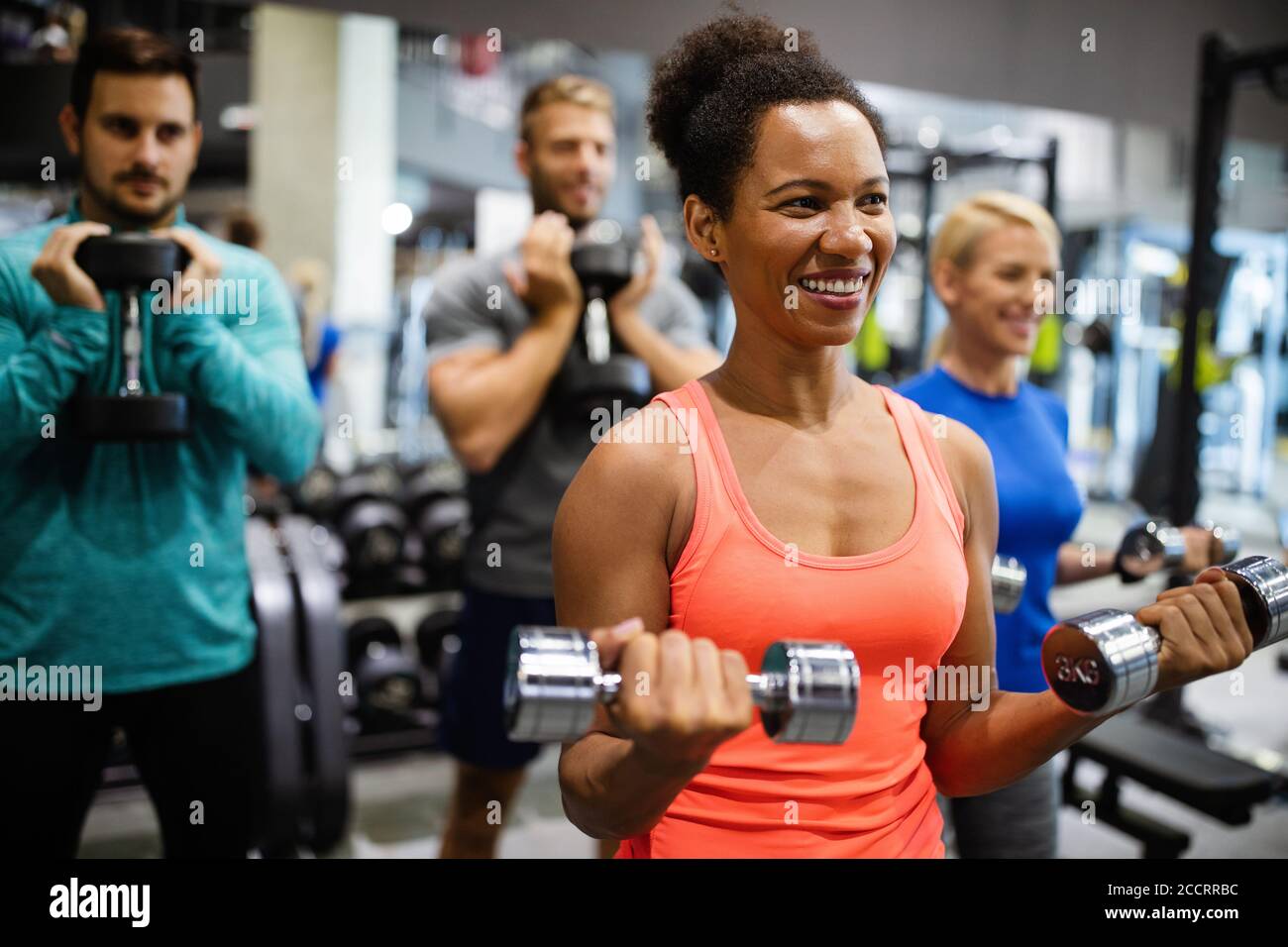 Cheerful friends doing exercises together hi-res stock photography and ...