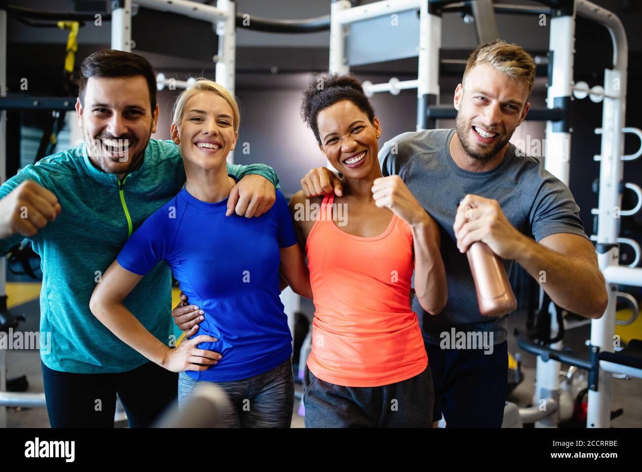 Group of young friends people doing exercises in gym Stock Photo - Alamy