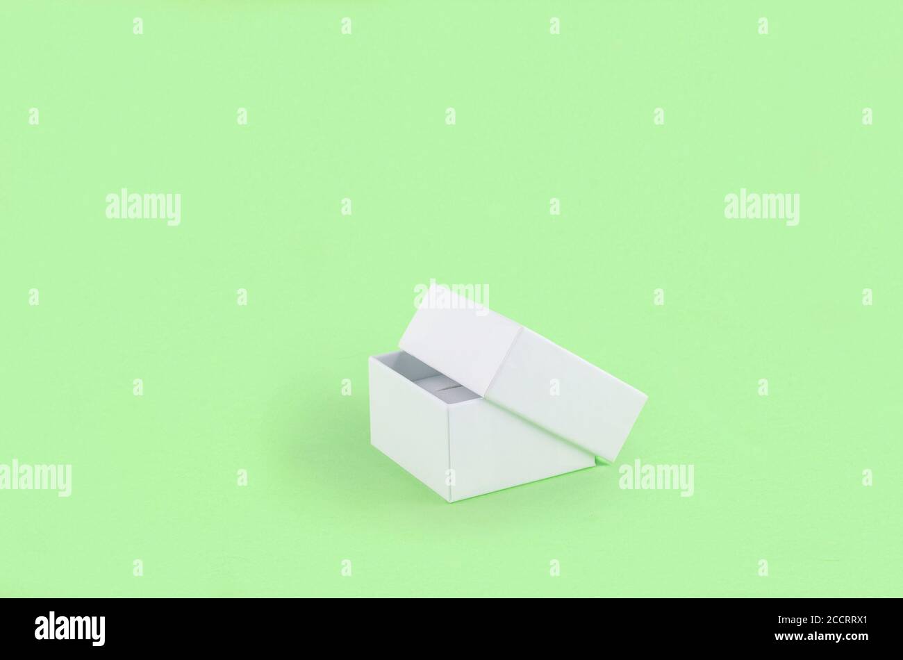 Open white gift box with shadows on a light green background Stock ...