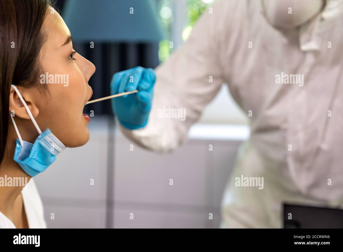 Medical staff with PPE suit test coronavirus covid-19 to asian woman by ...