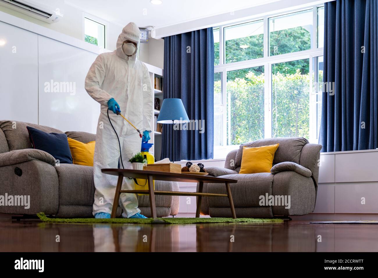 Asian Medical staff in personal protective equipment PPE suit spraying ...