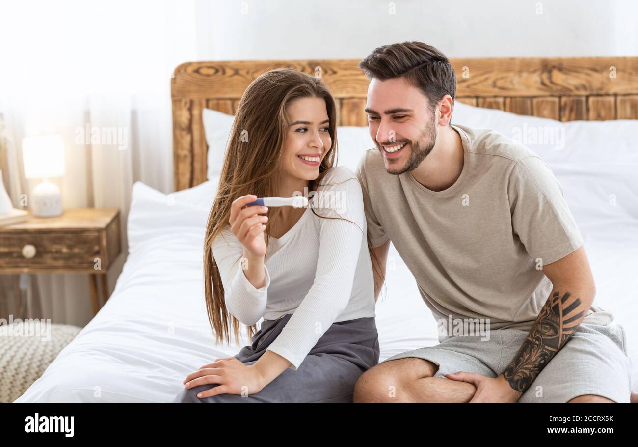 Surprise and future parents. Happy man and woman are looking at ...