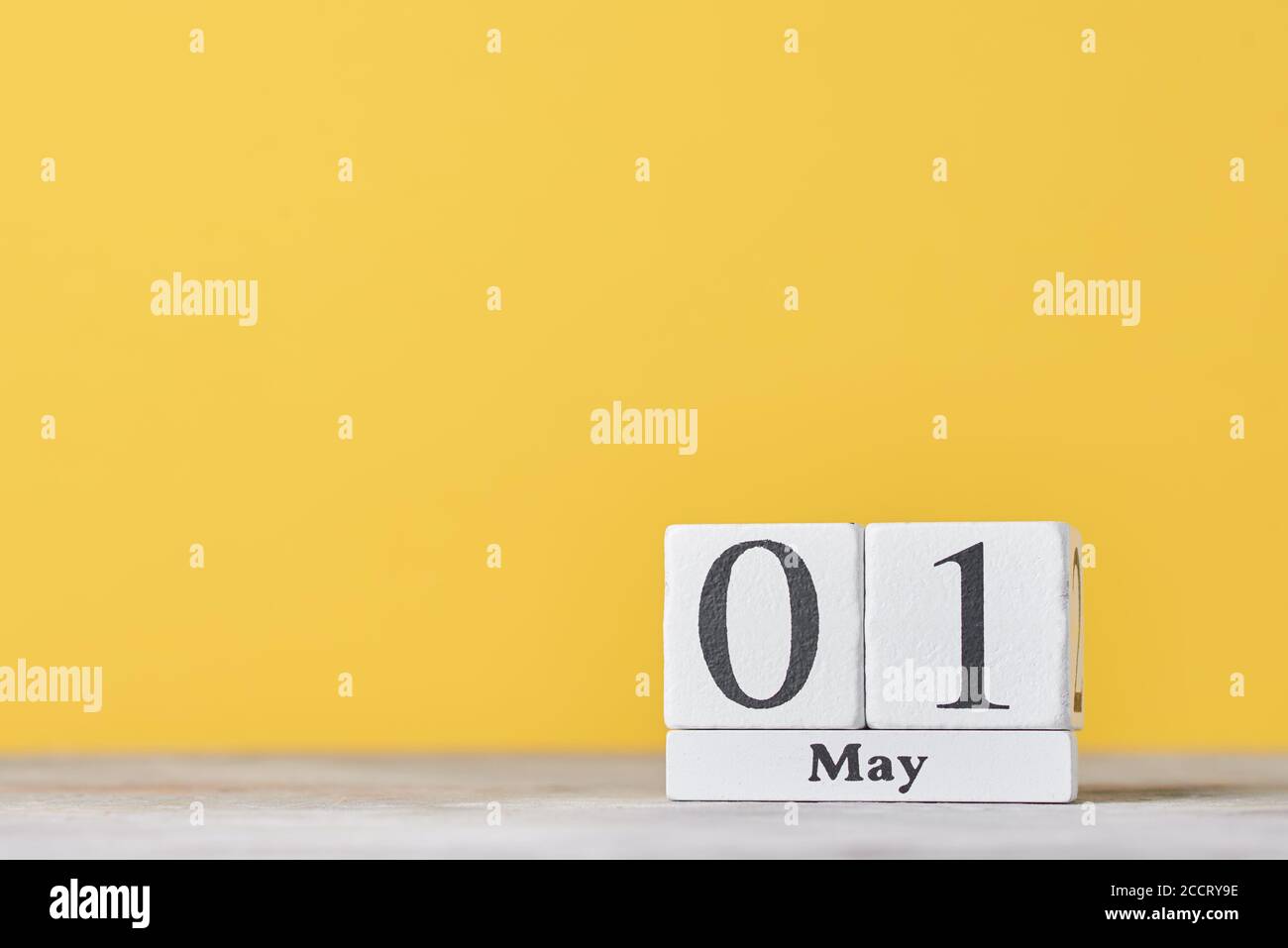 Wooden block calendar with date May 1 on yellow background. Labor Day ...