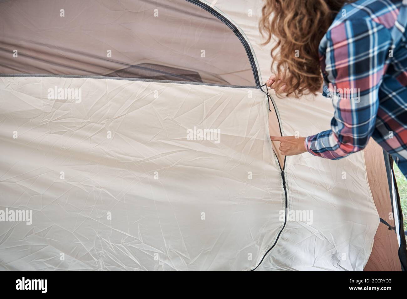 Woman setting up camping tent at forest, close up Stock Photo - Alamy