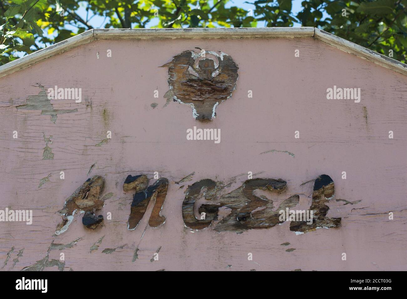 An old decaying sign with the word and symbol for "angel Stock Photo ...