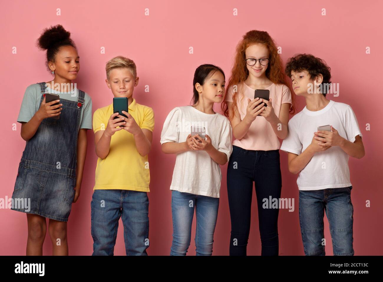 Multiethnic kids using cellphones hi-res stock photography and images ...