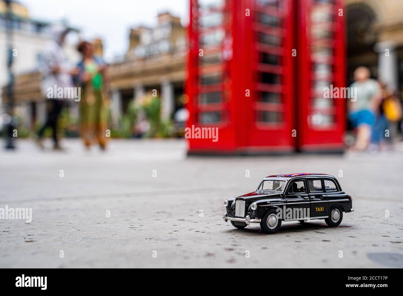 Closeup shot of a traditional black cab driving through the most famous ...