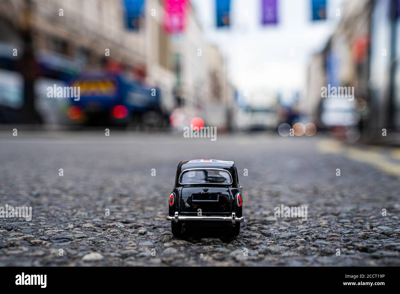 Closeup shot of a traditional black cab driving through the most famous ...