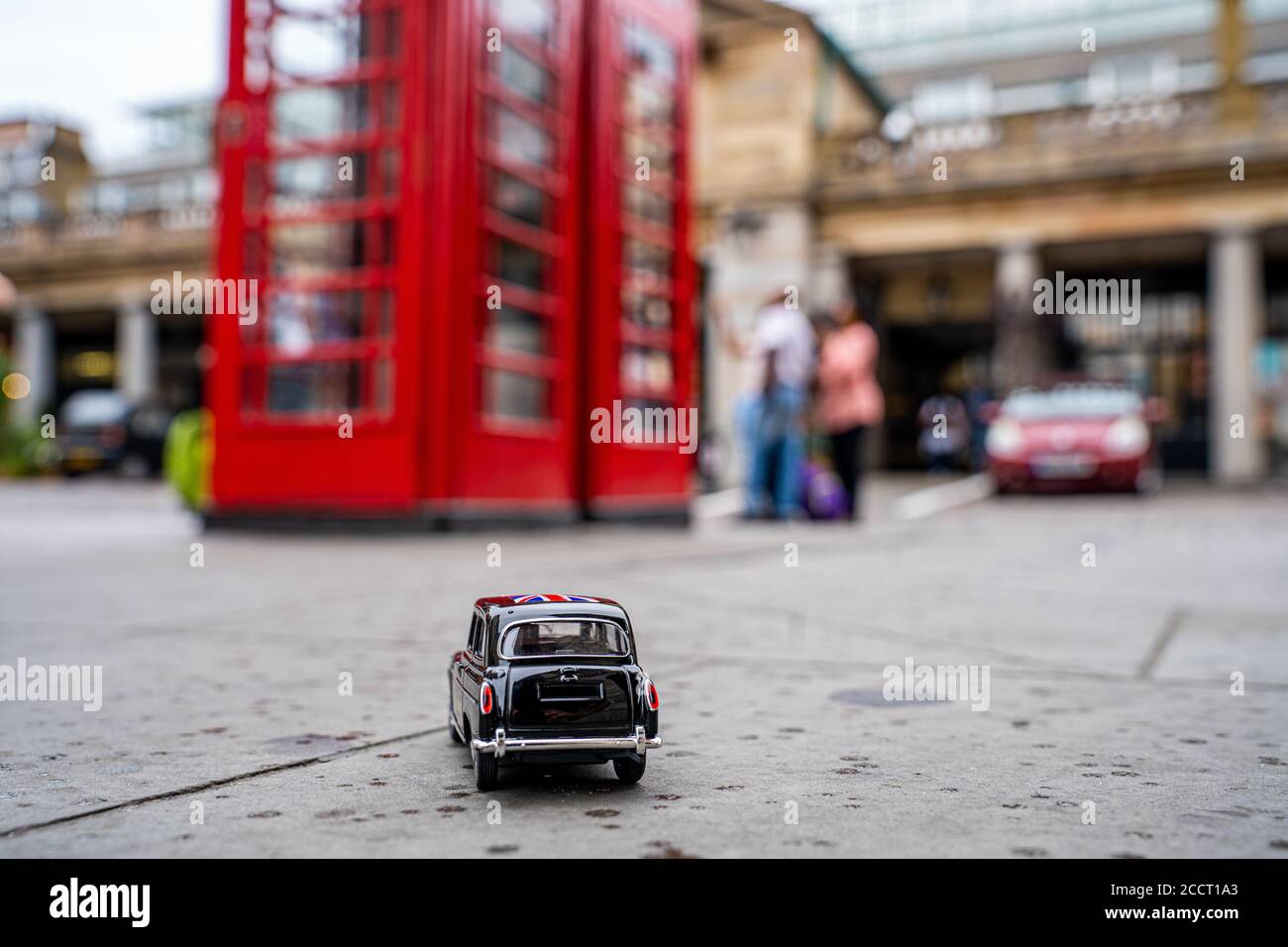 Closeup shot of a traditional black cab driving through the most famous ...