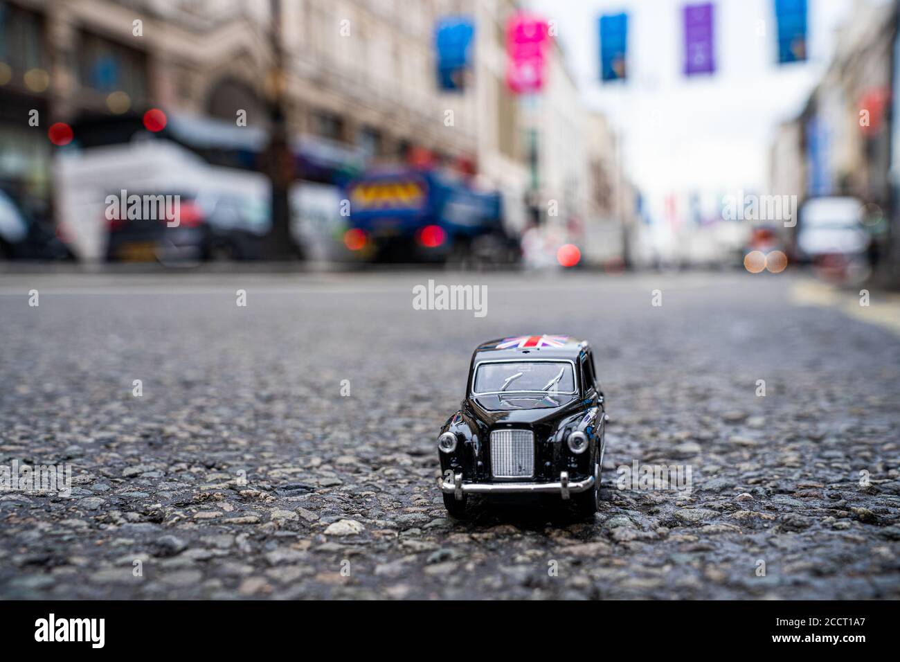 Closeup shot of a traditional black cab driving through the most famous ...