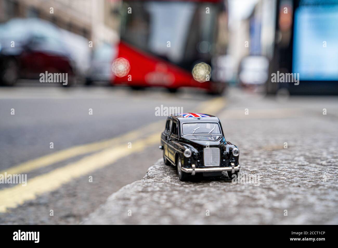 Closeup shot of a traditional black cab driving through the most famous ...