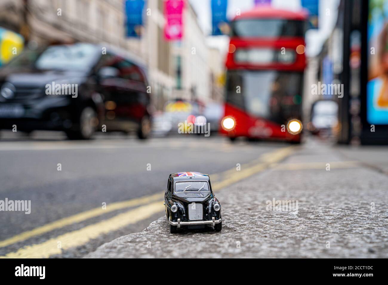 Closeup shot of a traditional black cab driving through the most famous ...