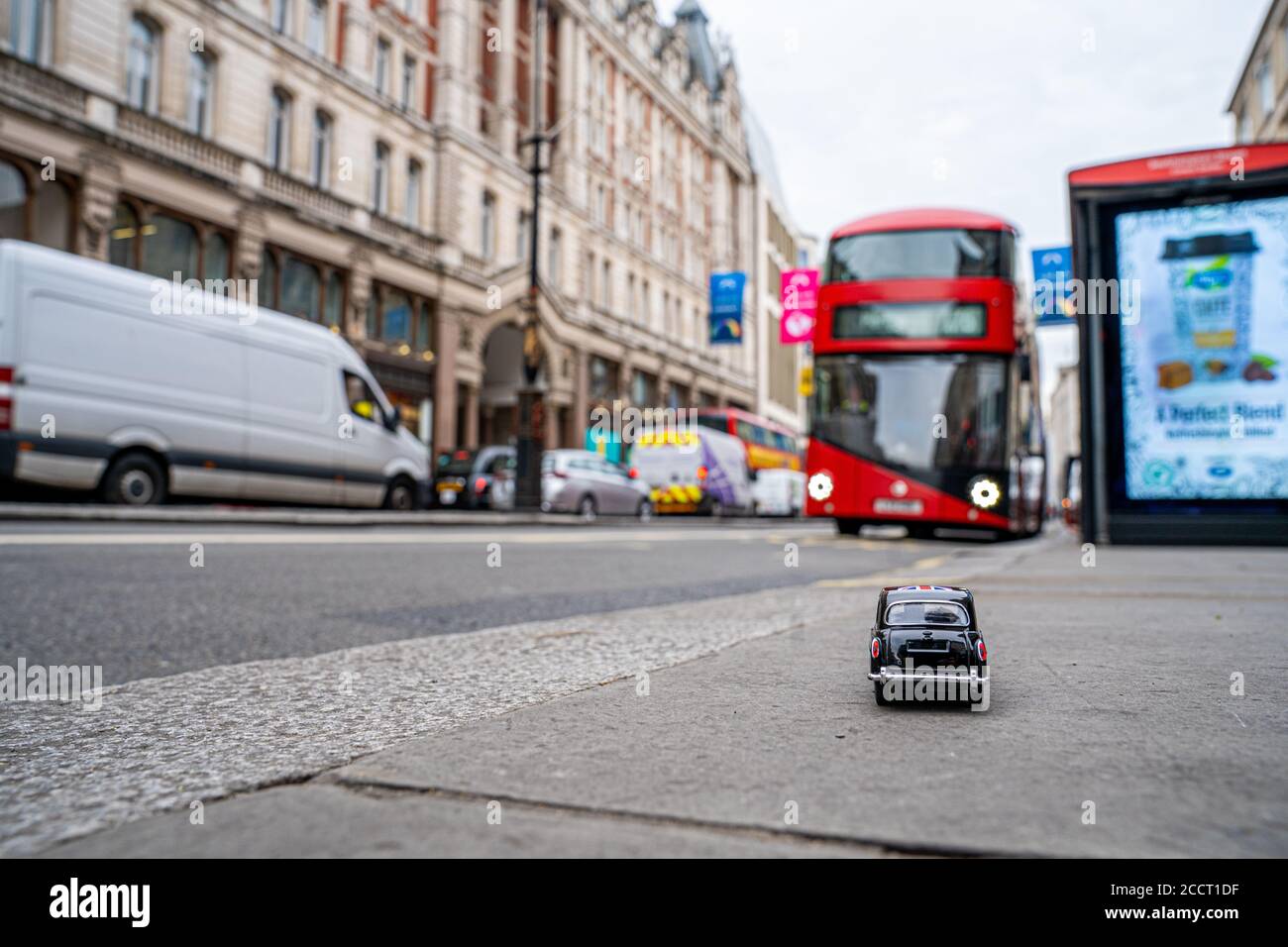 Closeup shot of a traditional black cab driving through the most famous ...