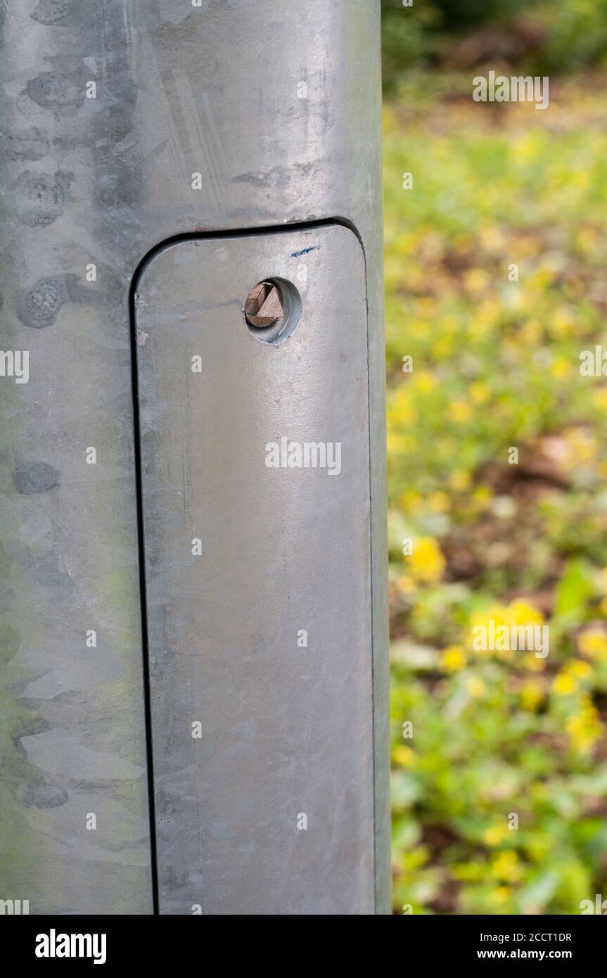 the cover of a maintenance opening at a lamp post fixed with a ...