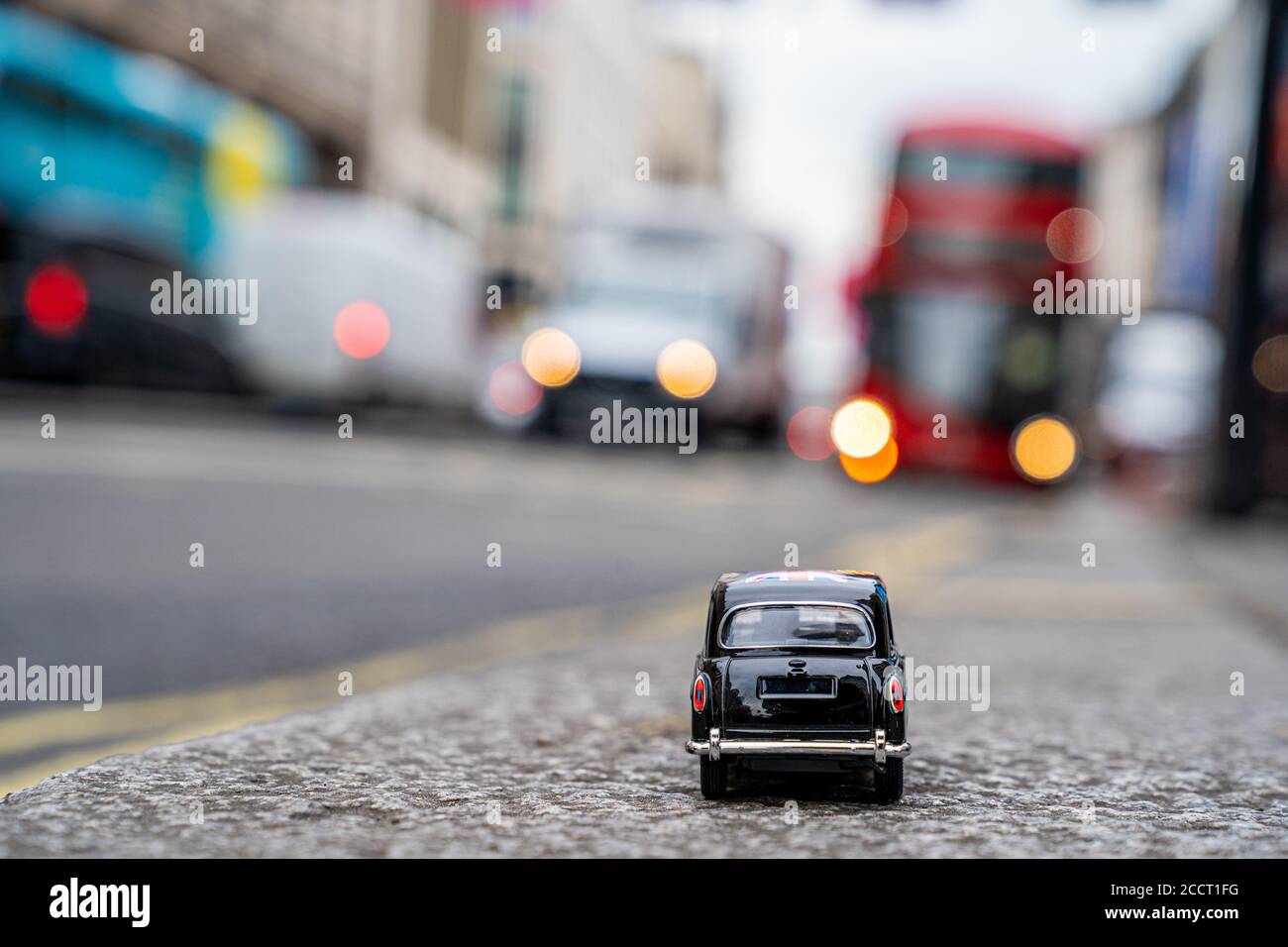 Closeup shot of a traditional black cab driving through the most famous ...