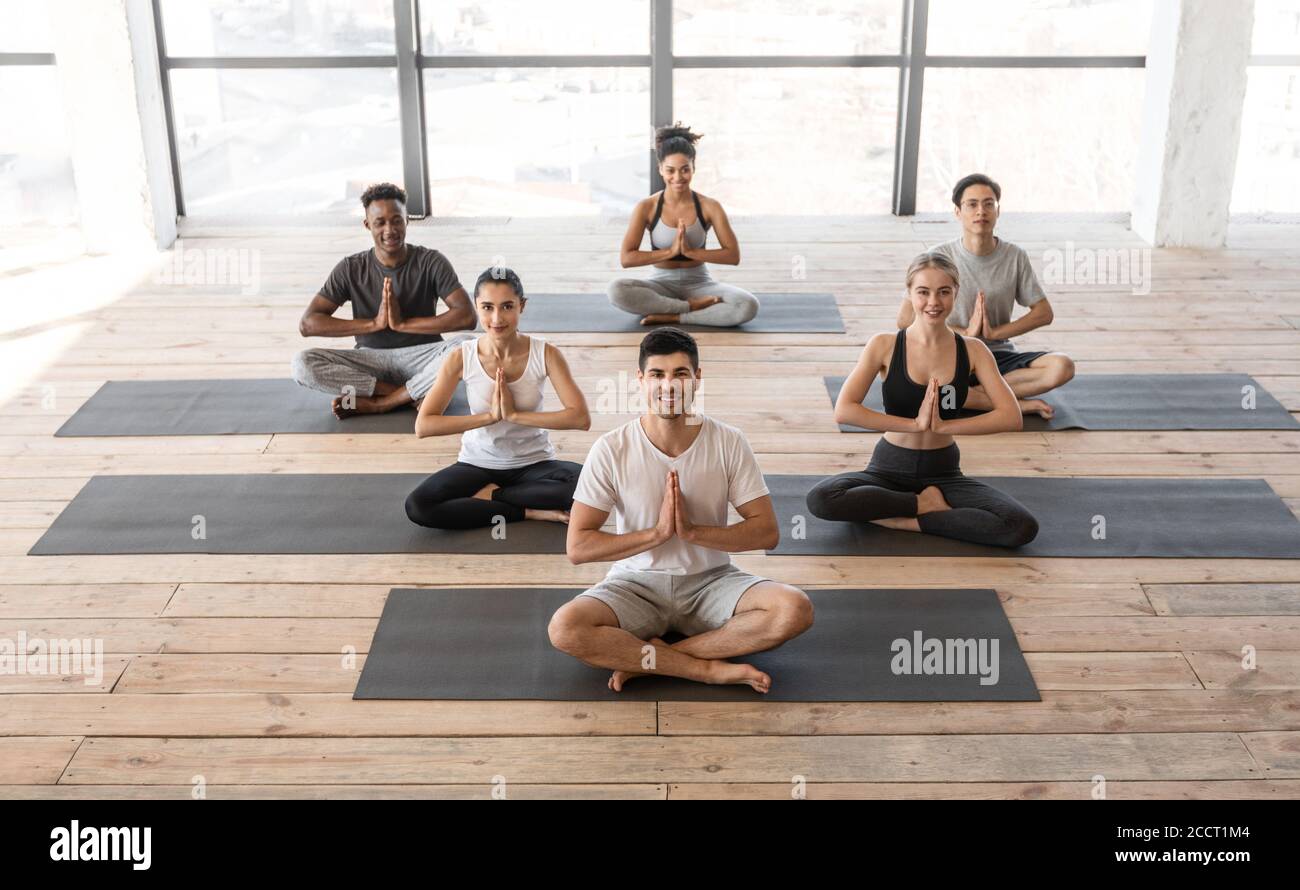 Diverse group people practicing yoga hi-res stock photography and ...