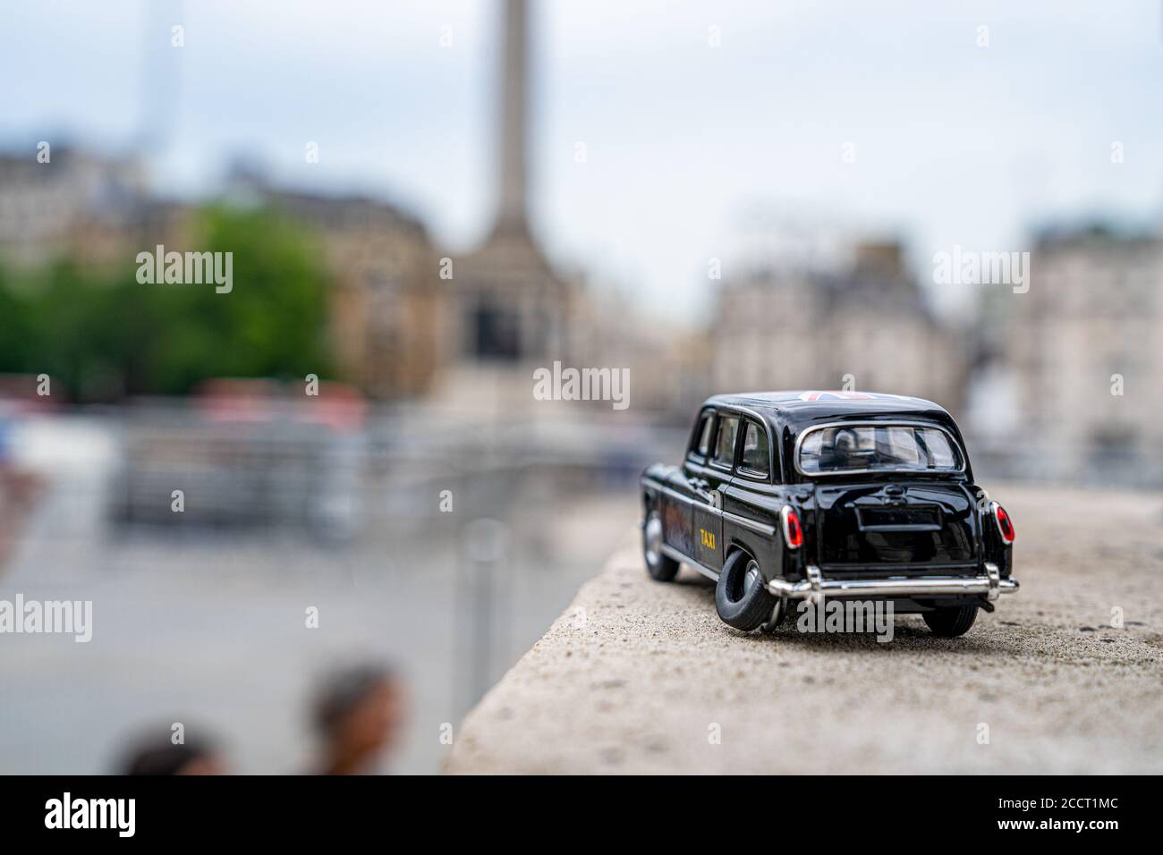 Closeup shot of a traditional black cab driving through the most famous ...