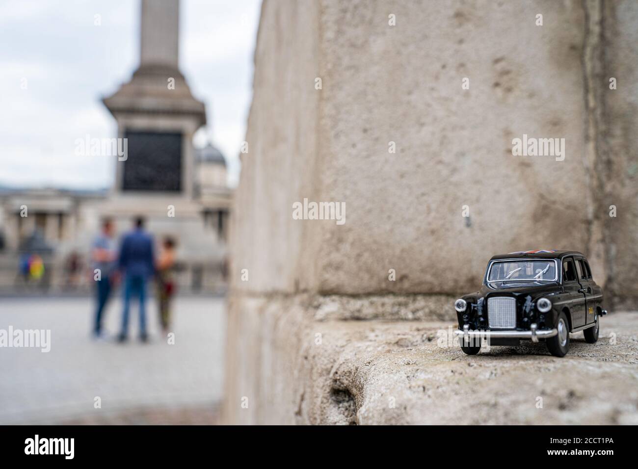Closeup shot of a traditional black cab driving through the most famous ...