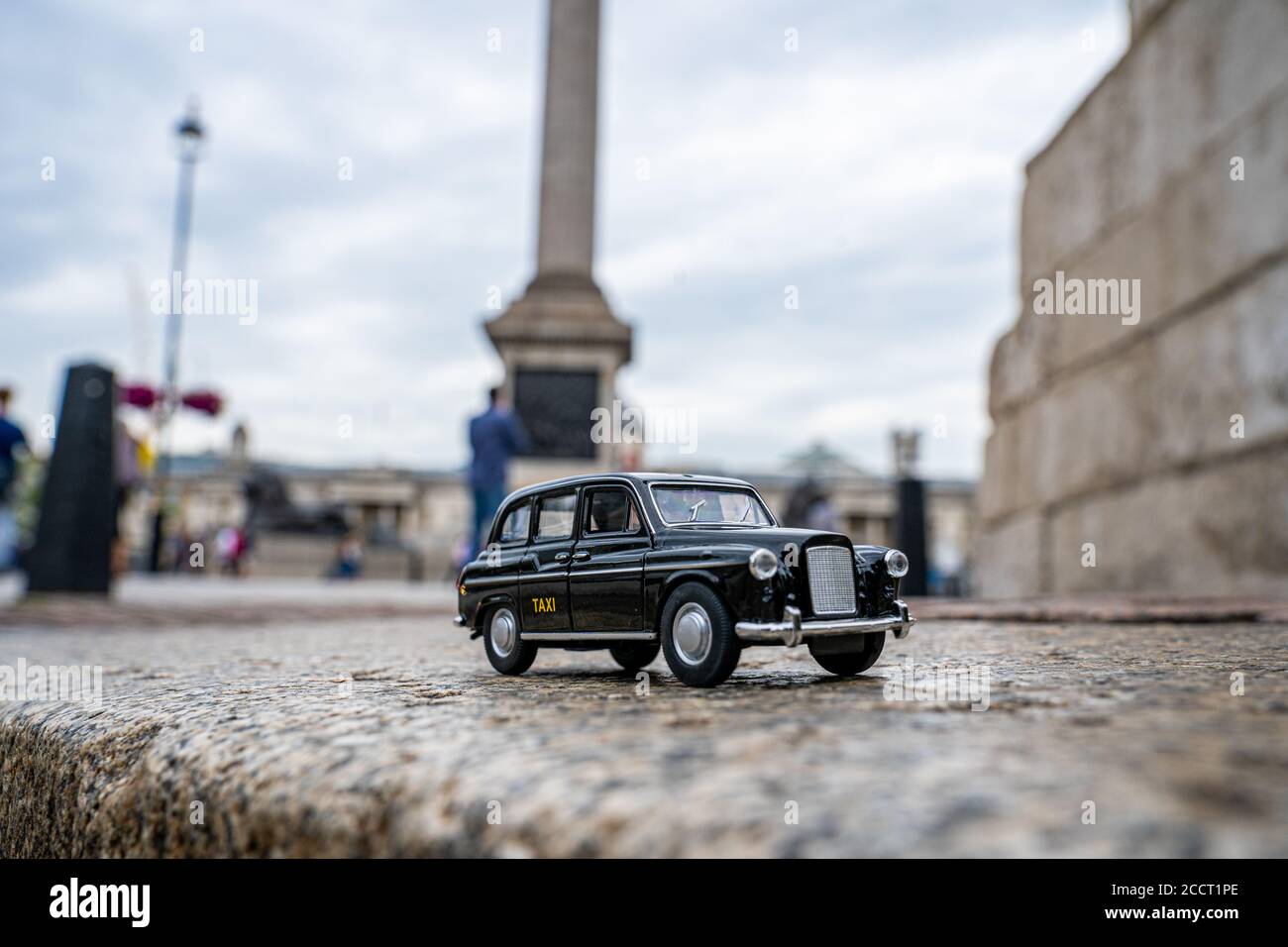 Closeup shot of a traditional black cab driving through the most famous ...