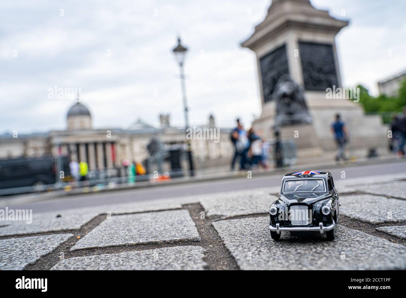 Closeup shot of a traditional black cab driving through the most famous ...