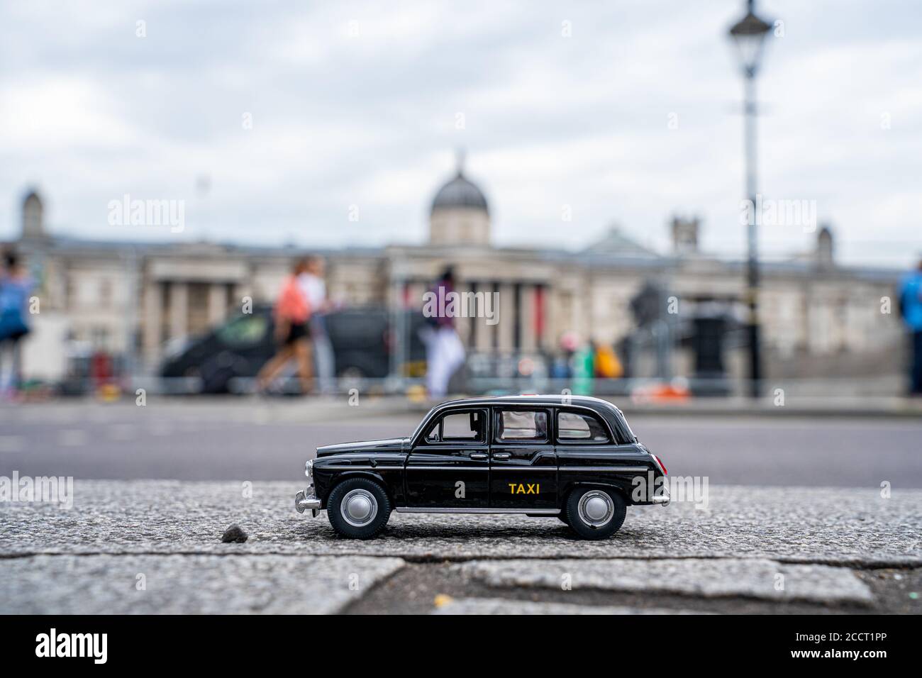 Closeup shot of a traditional black cab driving through the most famous ...