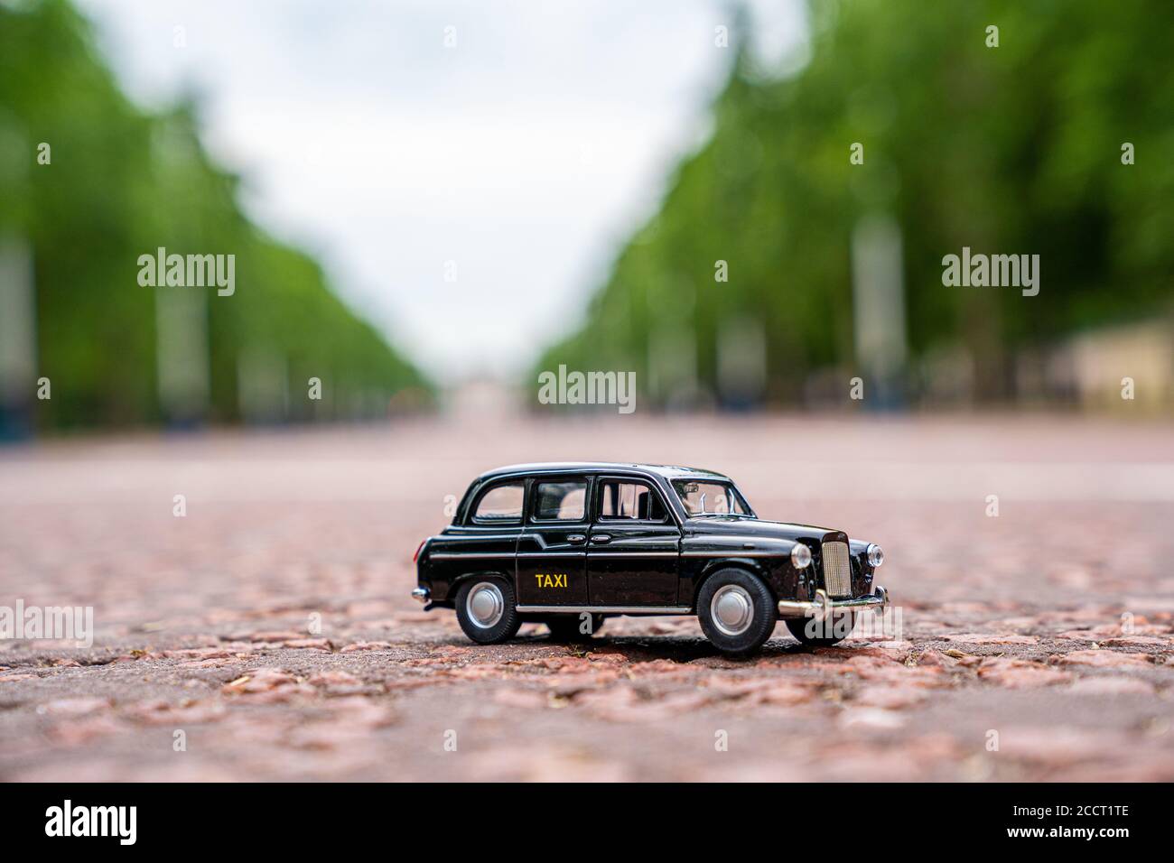 Closeup shot of a traditional black cab driving through the most famous ...