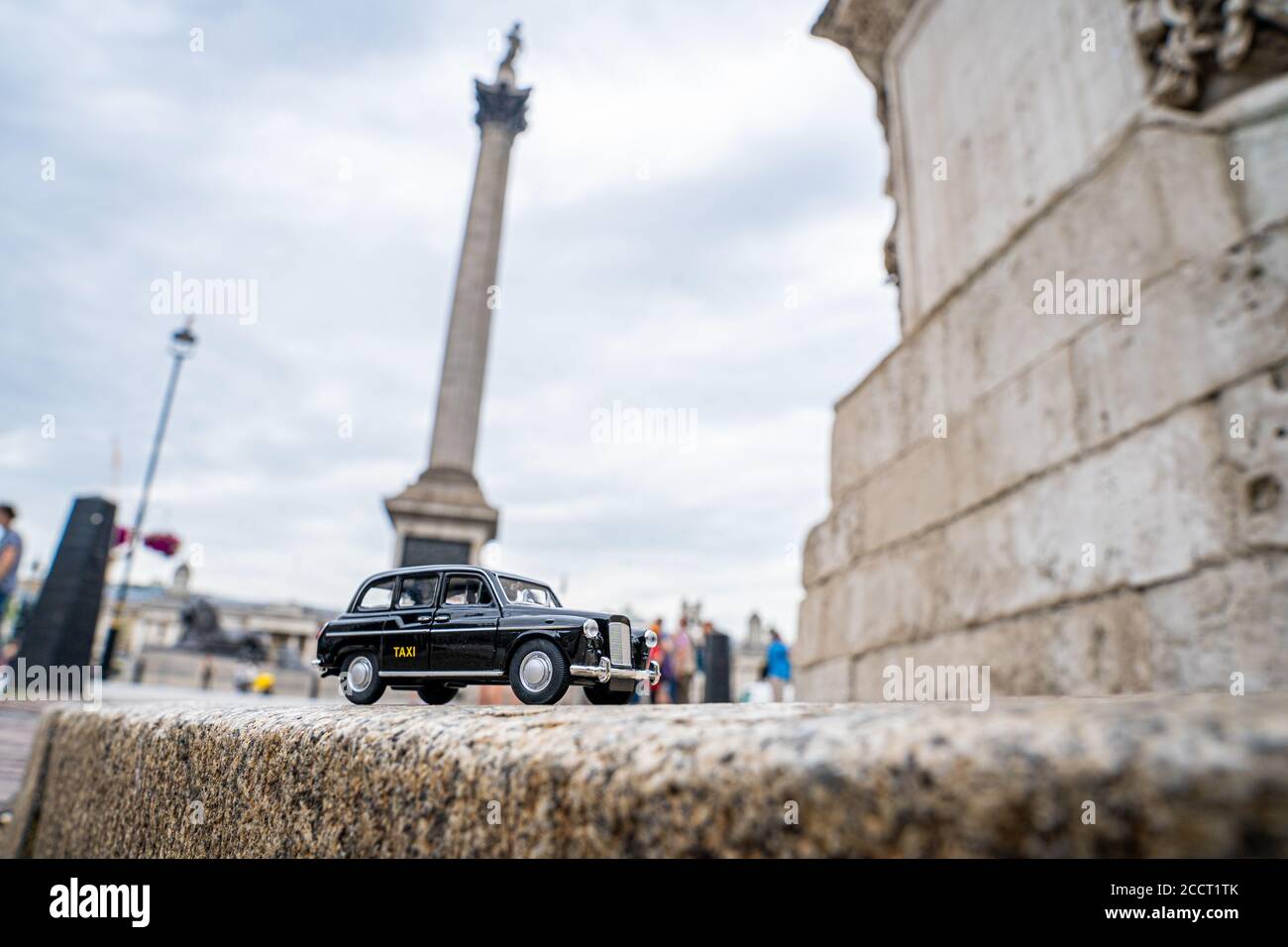 Closeup shot of a traditional black cab driving through the most famous ...