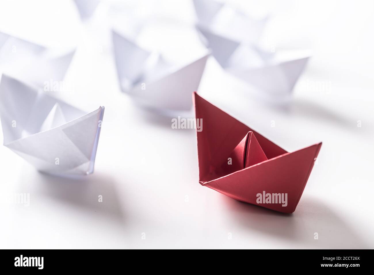 Red and white paper boats. Concept of leadership boats for teamwork ...