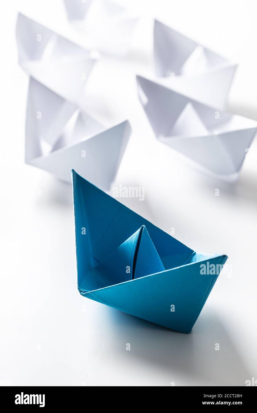 Blue and white paper boats. Concept of leadership boats for teamwork ...