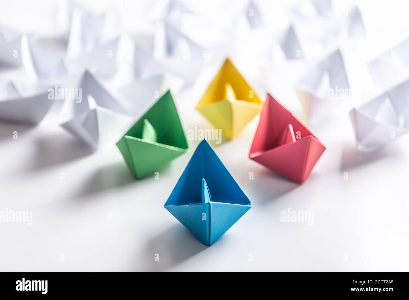 Multi colored paper boats. Concept of leadership boats for teamwork ...