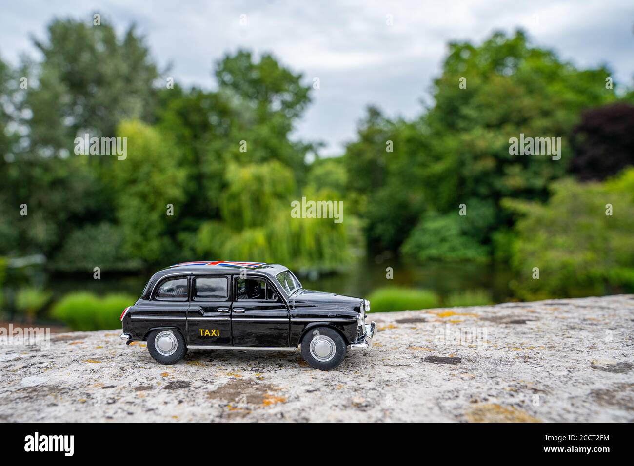 Closeup shot of a traditional black cab driving through the most famous ...