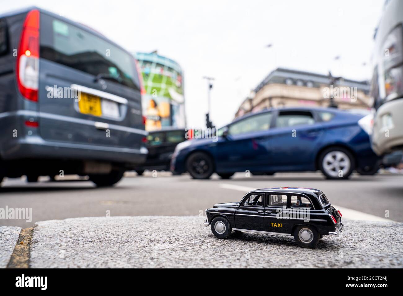 Closeup shot of a traditional black cab driving through the most famous ...