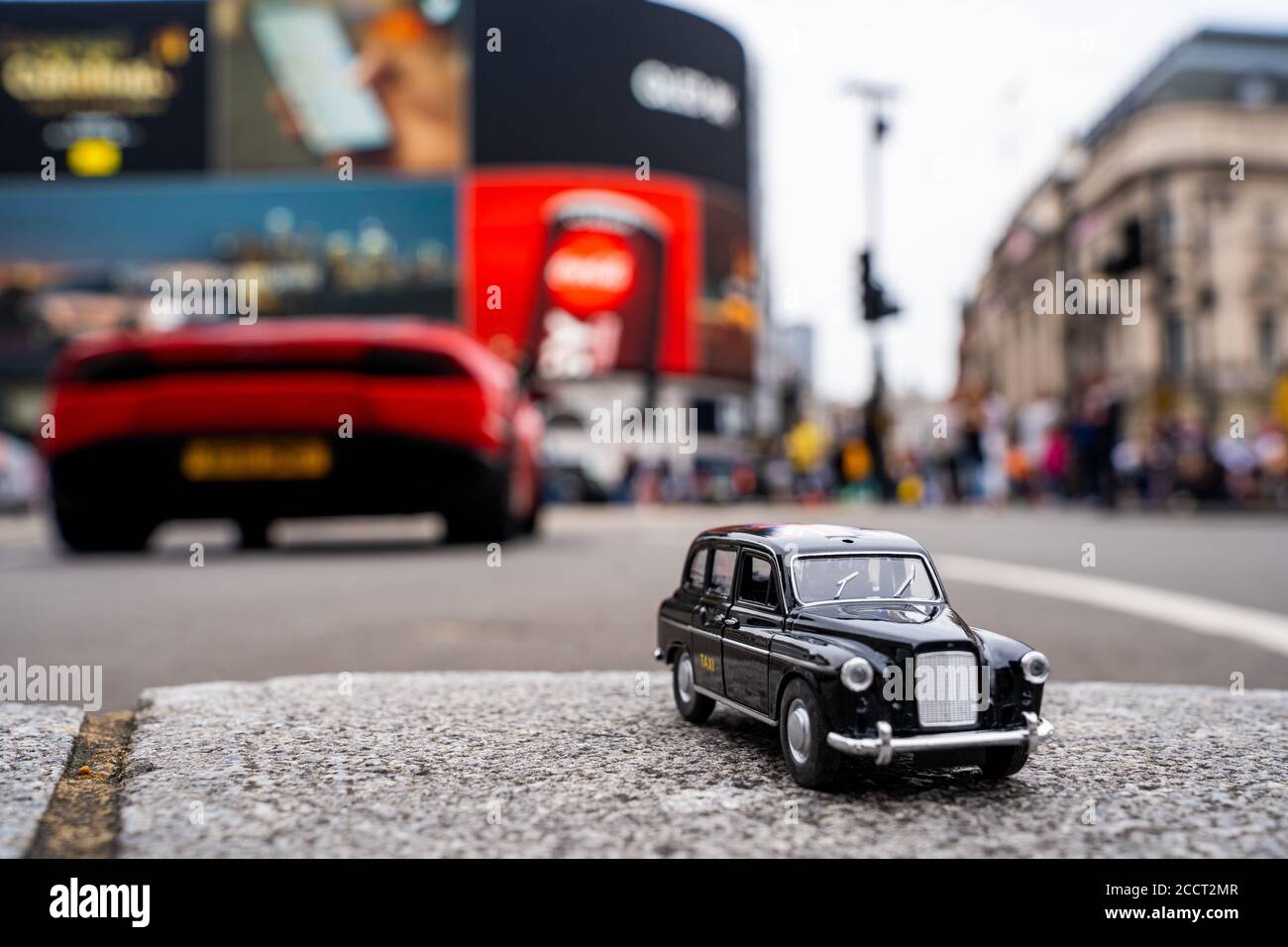 Closeup shot of a traditional black cab driving through the most famous ...