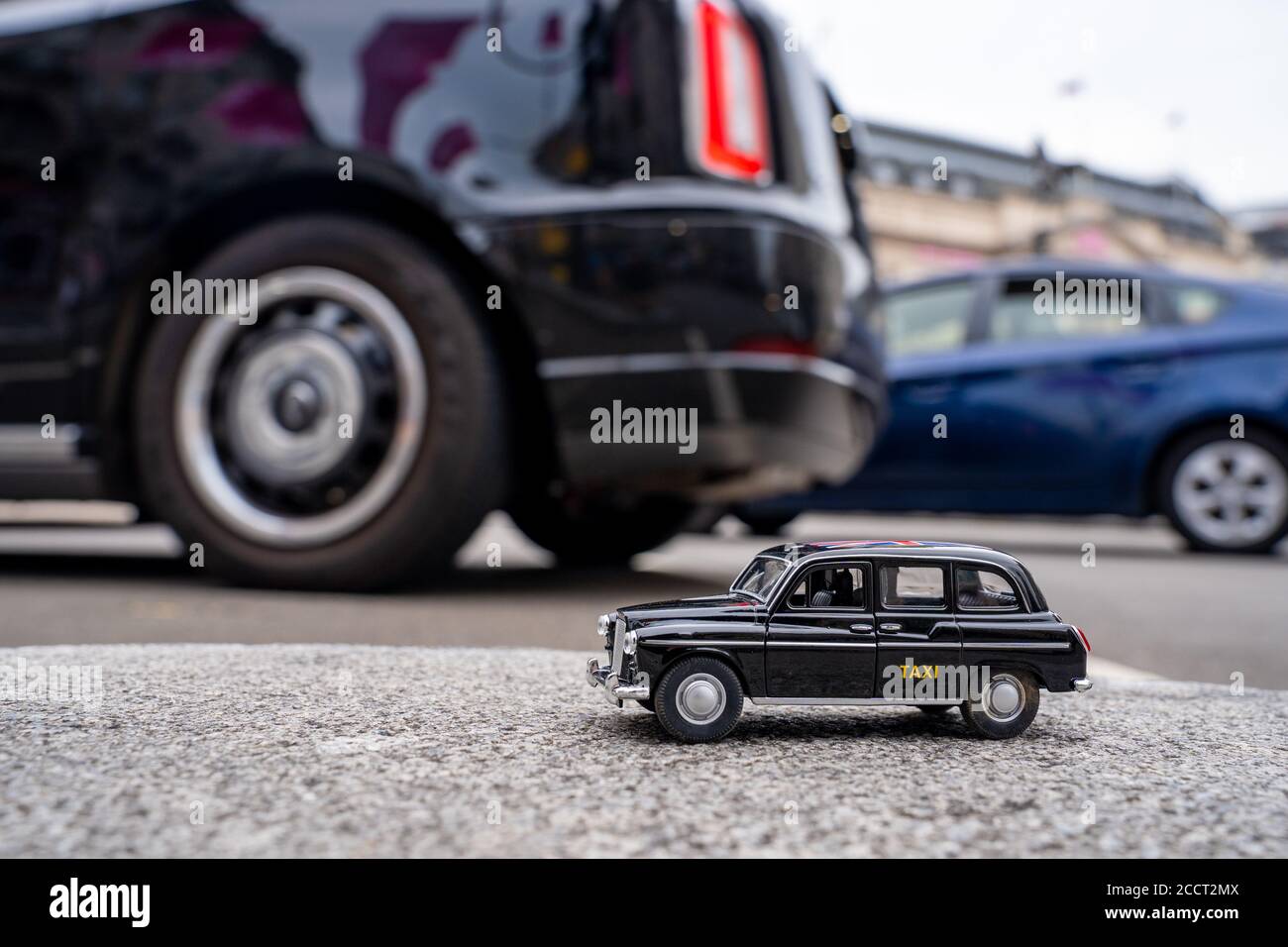 Closeup shot of a traditional black cab driving through the most famous ...
