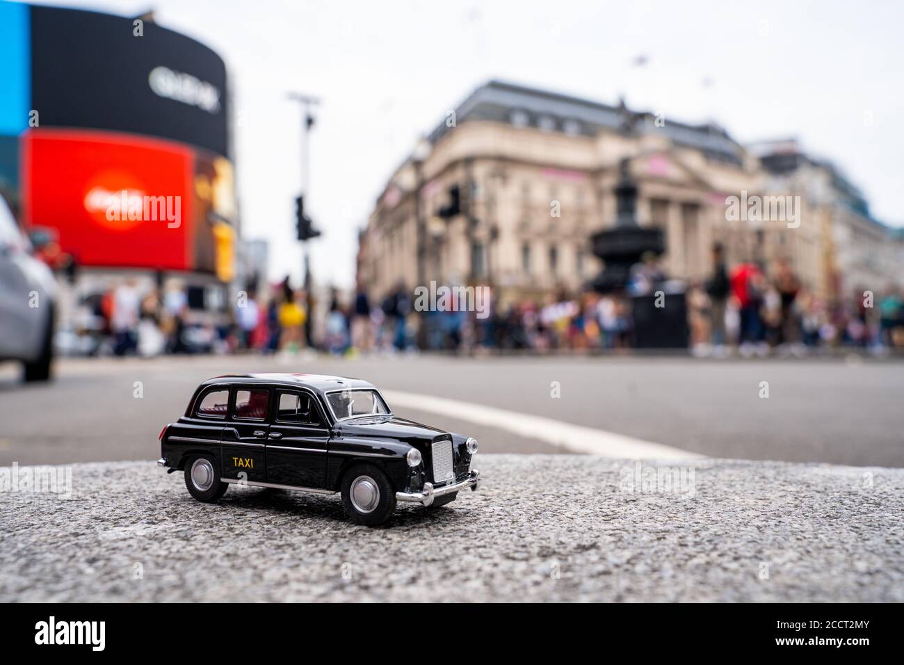 Closeup shot of a traditional black cab driving through the most famous ...