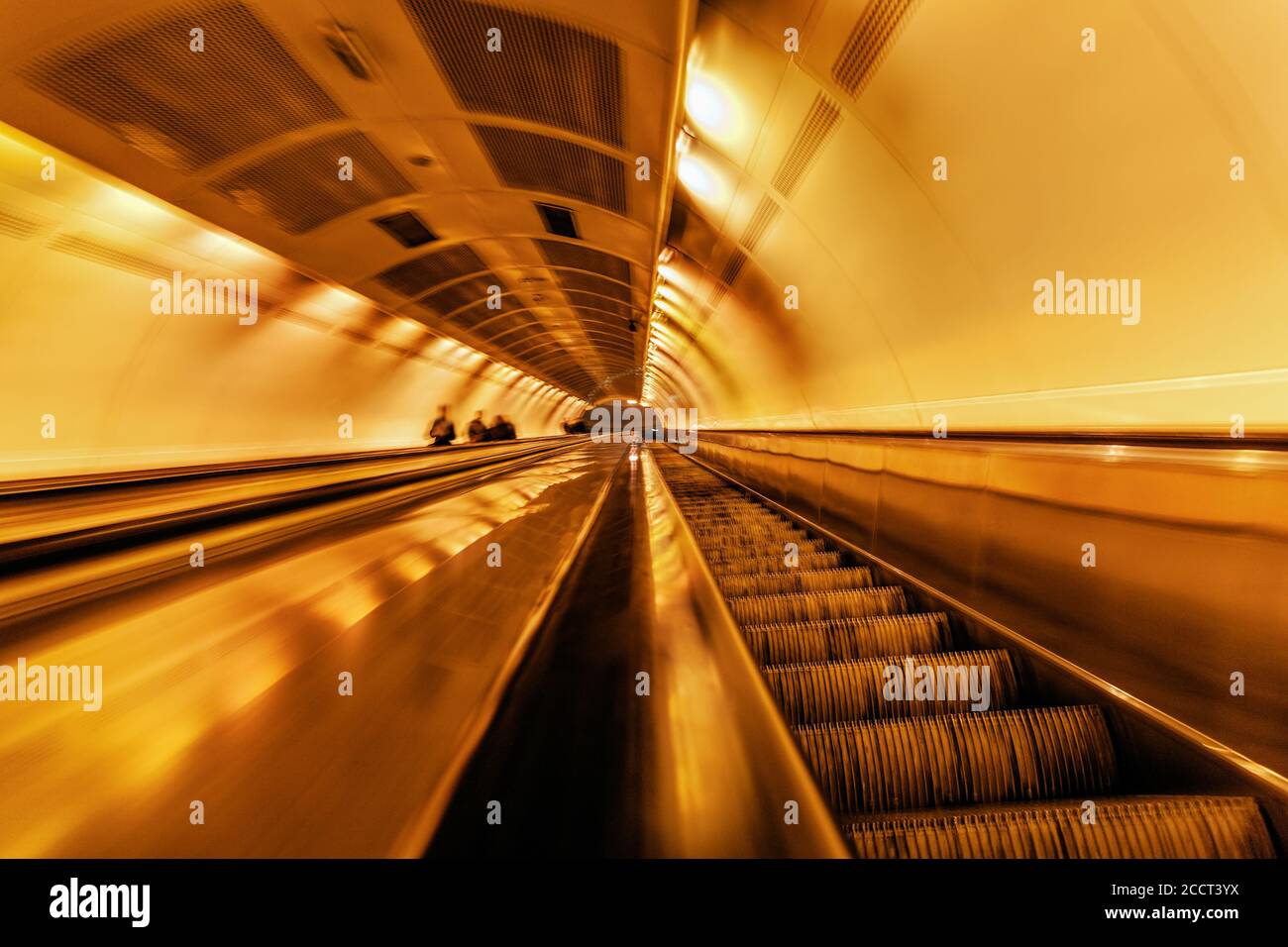 Moving stairs in the underground passage at blur background Stock Photo ...