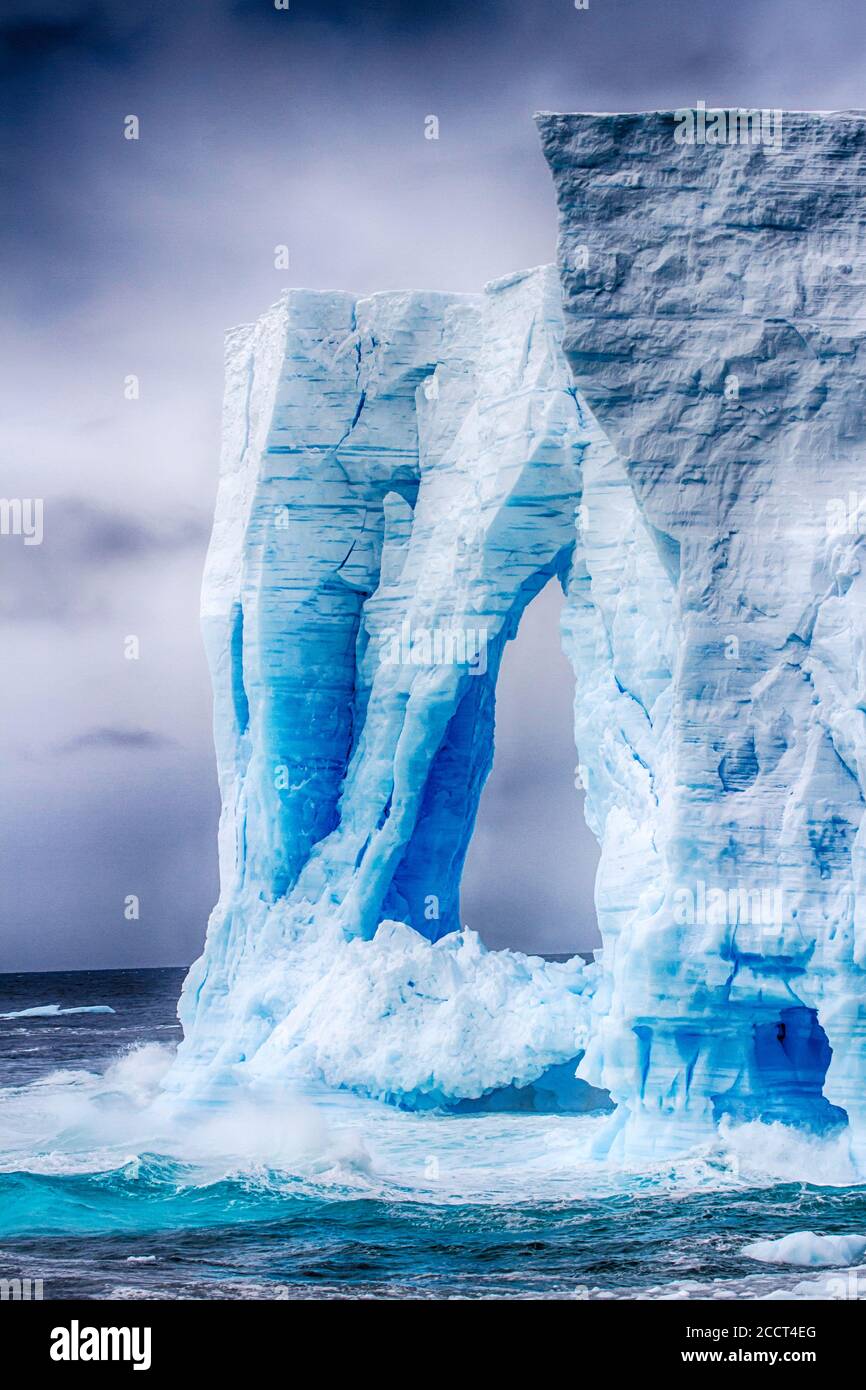 Tower formation with arches formed in glacial tabular iceberg in ...