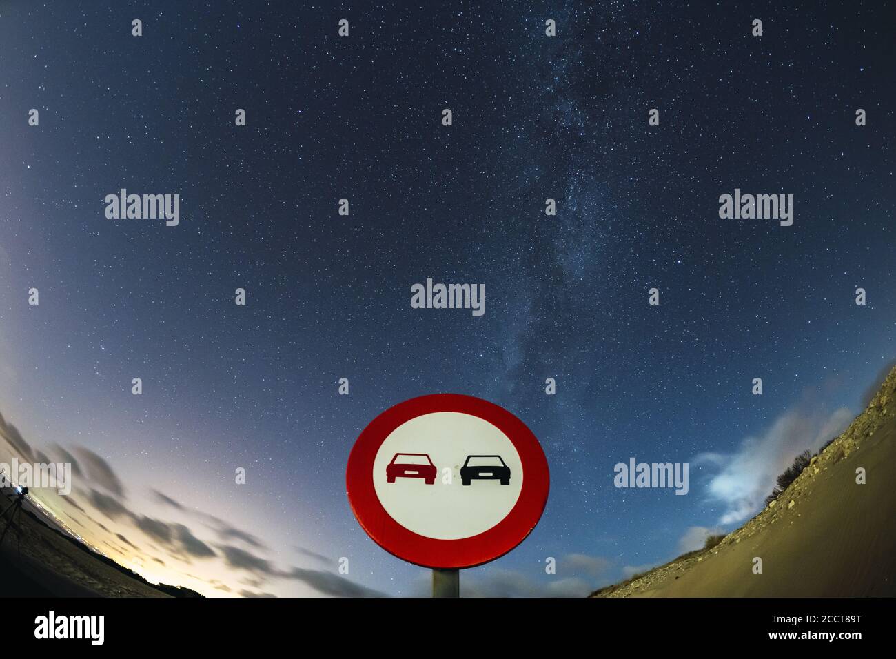 No overtaking road sign under the night sky with the milky way at ...