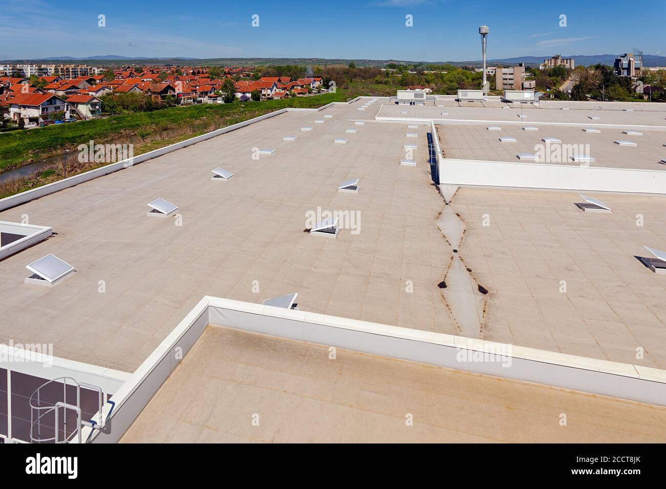 view of the industrial flat roof with roof windows and ventilation ...