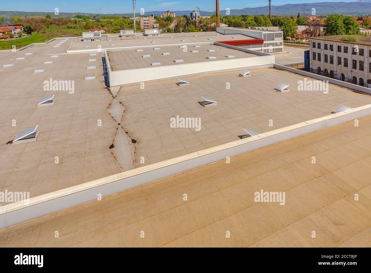 view of the industrial flat roof with roof windows and ventilation ...