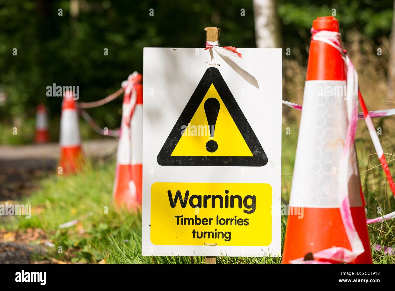 A warning sign of timber lorries turning with traffic cones Stock Photo ...