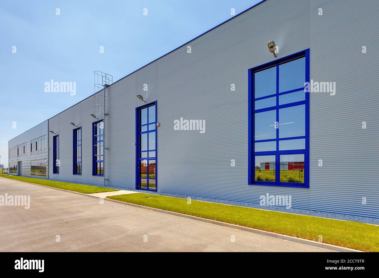 industrial building with blue windows Stock Photo - Alamy