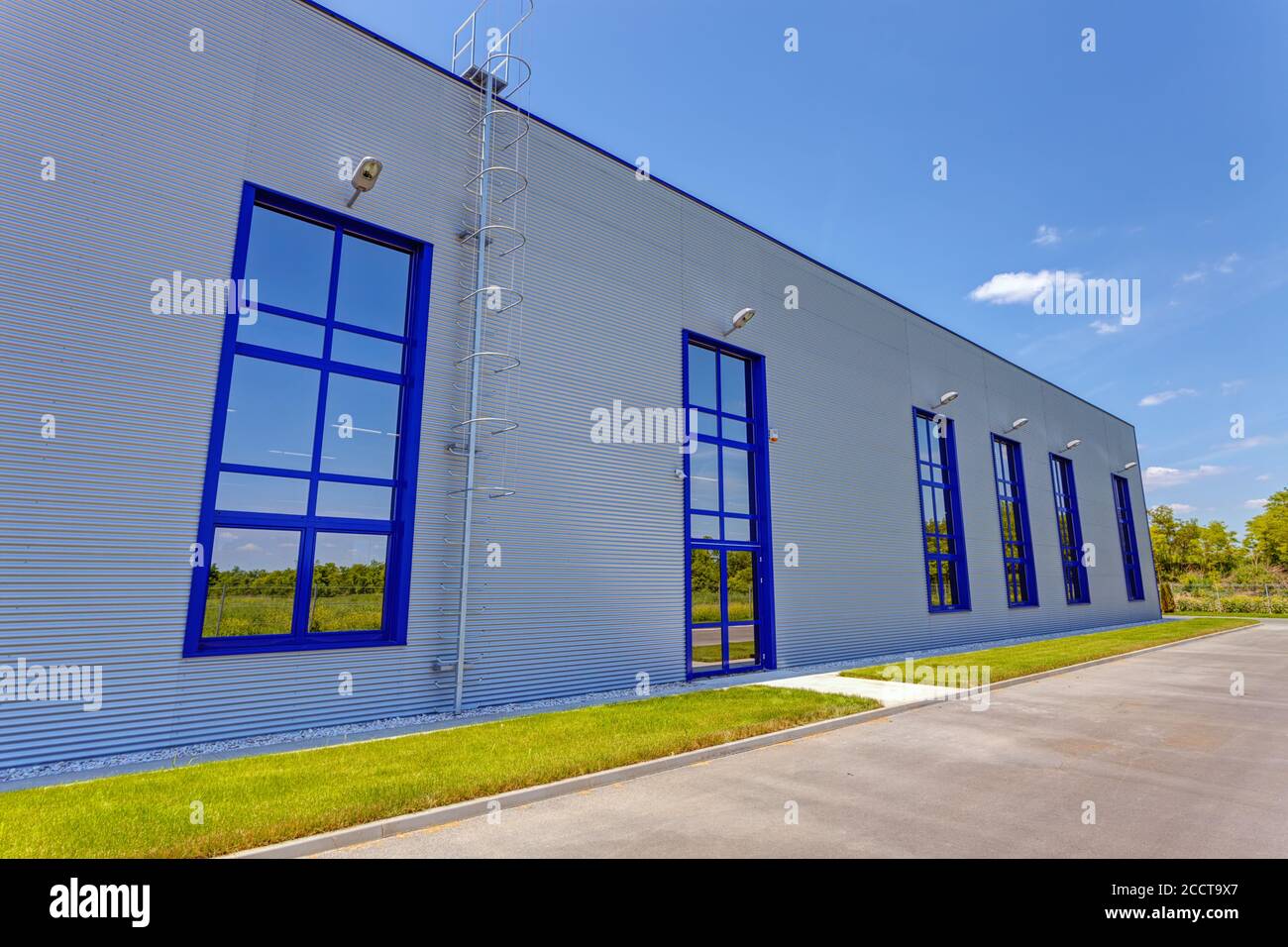 industrial building with blue windows Stock Photo - Alamy