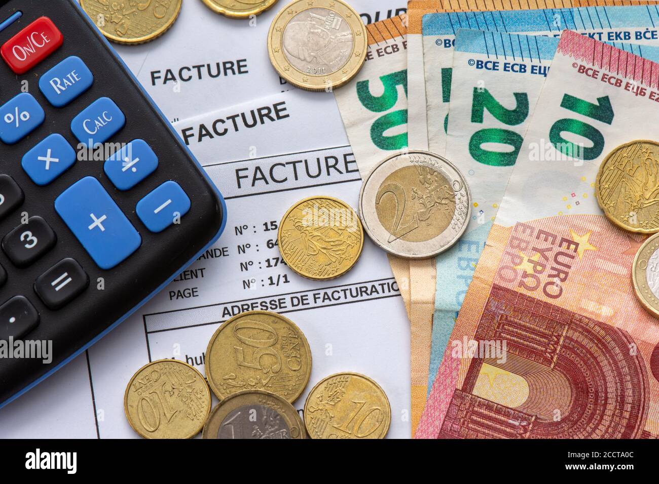 French invoices ("facture") with euro cash and a calculator Stock Photo ...